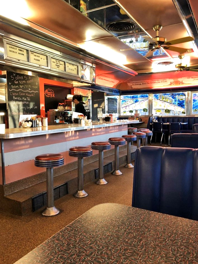 The counter view—where coffee steam rises, orders fly, and the rhythmic scrape of spatula on grill creates the soundtrack of comfort.