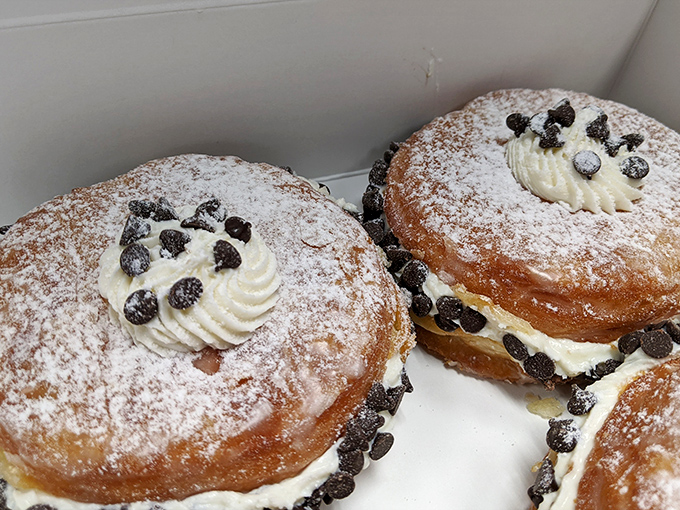 These cream-filled delights with chocolate chips aren't just donuts – they're what clouds would taste like if clouds were desserts.