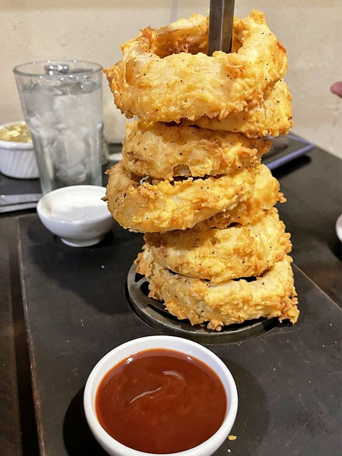 These aren't just onion rings—they're golden halos stacked like a savory Jenga tower, waiting to collapse into delicious chaos.