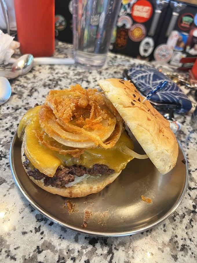 An onion ring crowning a burger is like putting a halo on an angel – it's already divine, but now it's officially blessed.