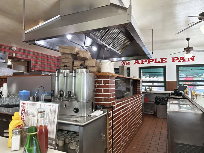 The open kitchen design means you can watch your burger's journey from raw patty to transcendent experience – dinner and a show!