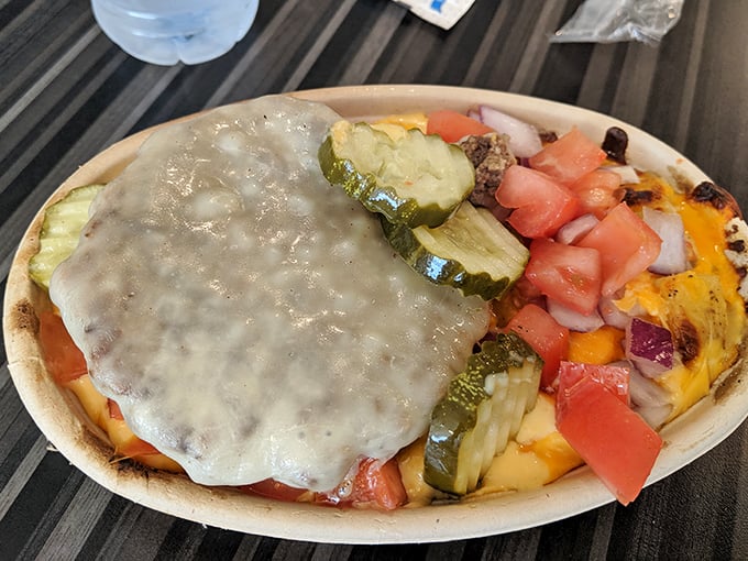 This mac and cheese creation comes with its own geography – mountains of toppings, valleys of sauce, and a pickle peninsula on the side.