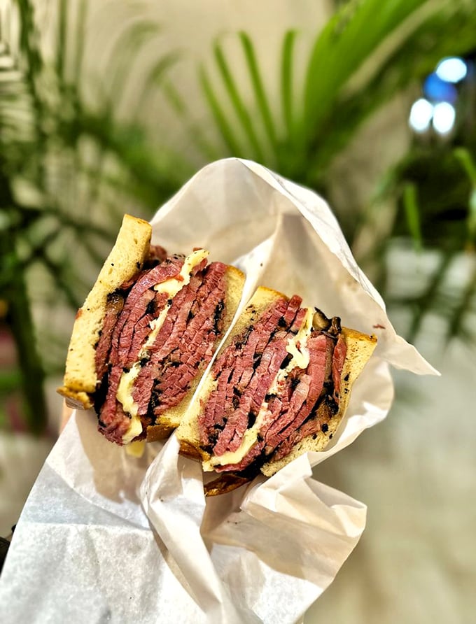 This isn't just a sandwich – it's architecture, it's history, it's a pastrami masterpiece wrapped in paper like the gift to humanity it truly is.