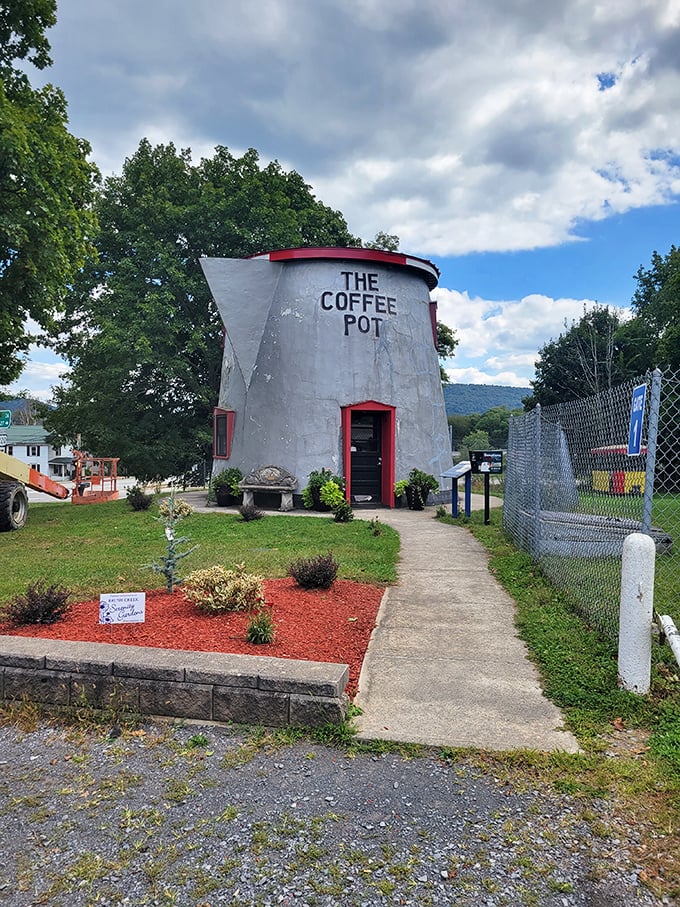 The pathway to The Coffee Pot is lined with carefully tended plants—a red carpet welcome to America's most caffeinated architectural oddity.