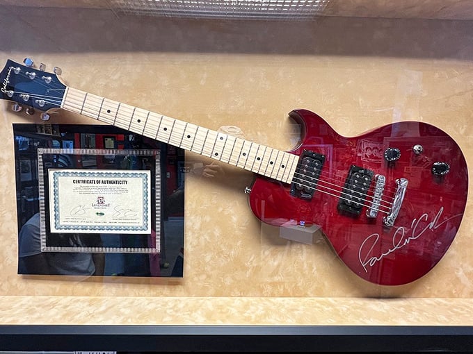 That cherry-red Gibson isn't just any guitar—it bears Paul McCartney's signature. Some instruments make music; this one made history.
