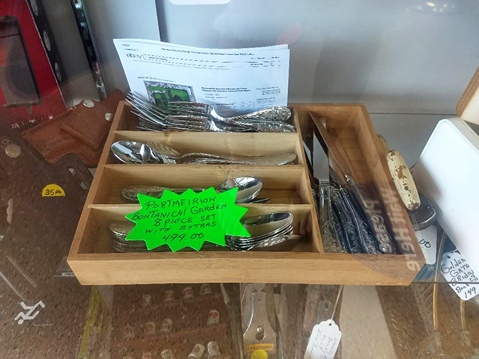 Silverware sets nestled in wooden dividers—the aristocrats of the utensil world, waiting to elevate someone's dining experience without the aristocratic price.