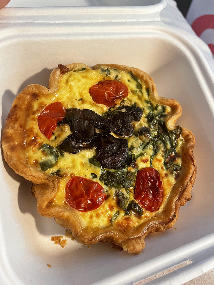 This quiche isn't just breakfast—it's a savory masterpiece with roasted tomatoes and greens standing at attention in a sea of perfect custard.