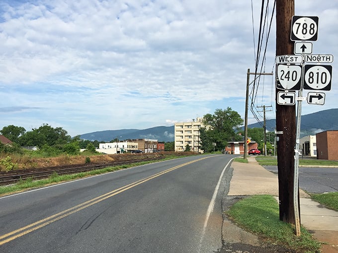 Highway signs point to adventures in every direction, while the Blue Ridge Mountains stand sentinel in the background—nature's own GPS for the soul.