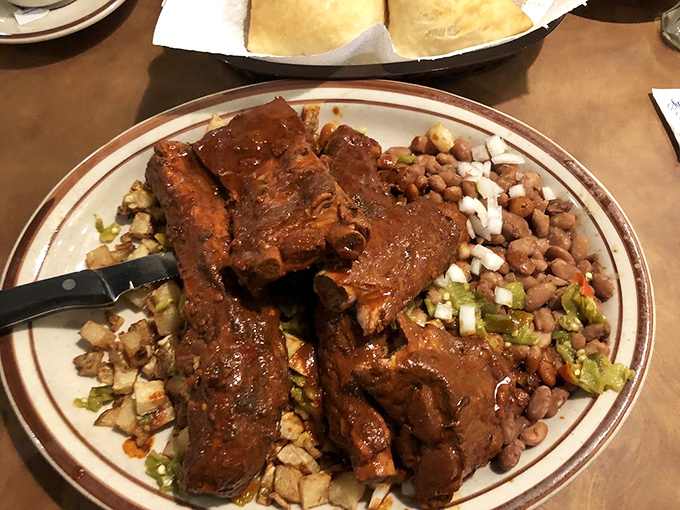 These ribs haven't just been cooked—they've been coaxed into tender submission by red chile that means serious business.