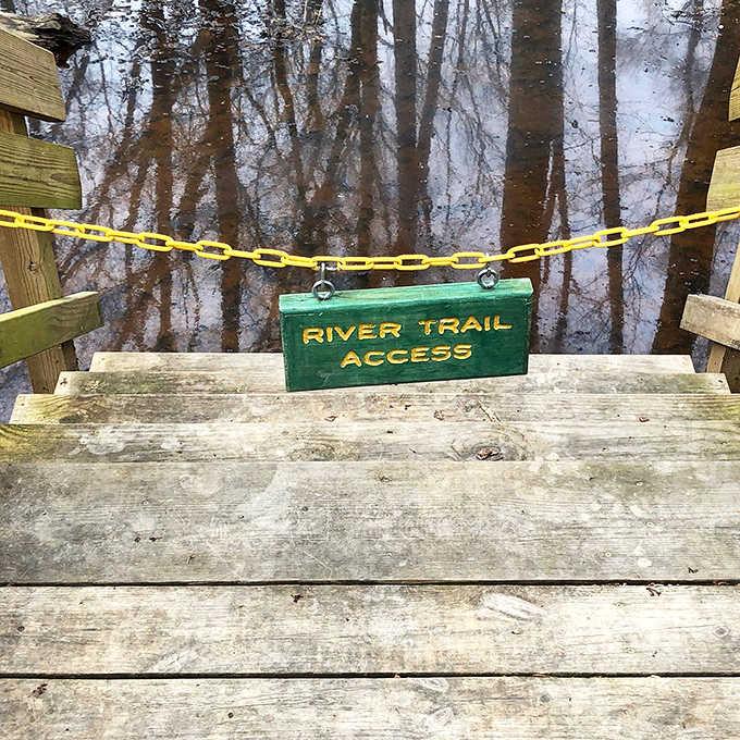 "River Trail Access" – three words that promise adventure, serenity, and possibly wet socks if you ignore that yellow chain.