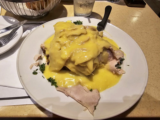 Turkey dinner that makes Thanksgiving jealous, smothered in sunshine-yellow hollandaise. This isn't just poultry—it's a celebration on a plate.