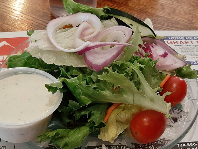 A simple side salad that knows its role—bringing crisp, fresh contrast to the parade of comfort classics heading your way.