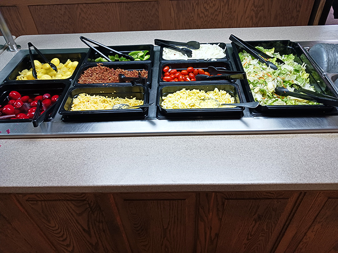 A salad bar that proves vegetables can be exciting too. Fresh ingredients arranged with care—because even side dishes deserve respect.