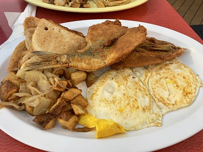 This isn't just breakfast – it's a morning feast with perfectly fried fish and eggs sunny enough to brighten any day.