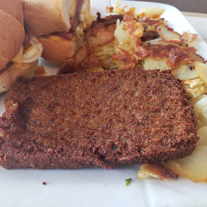 When breakfast meat deserves its own spotlight. Perfectly crisped, mysteriously delicious scrapple shares the plate with golden hash browns – a diner dream team.