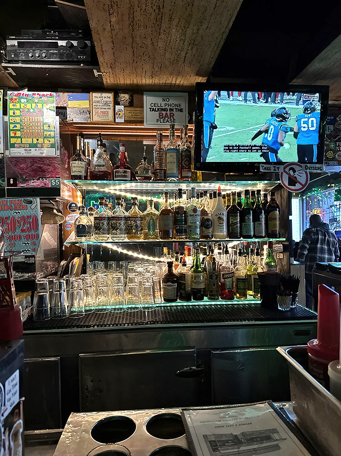 Behind every great dive bar is a well-stocked shelf of spirits—this one's illuminated like a shrine to good times and questionable decisions.