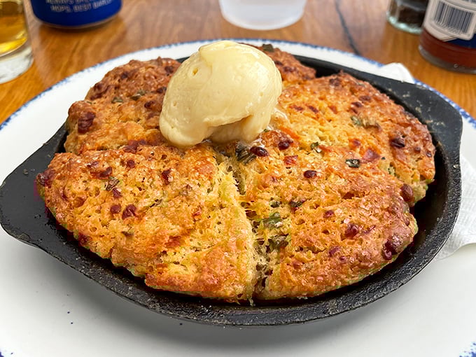 This cornbread arrives sizzling in its cast-iron throne, crowned with melting butter – Southern comfort that found a happy home in the North.