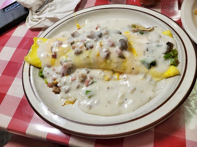 An omelet smothered in country gravy—where breakfast meets comfort food in a glorious union that makes you question why we don't eat this way every day.
