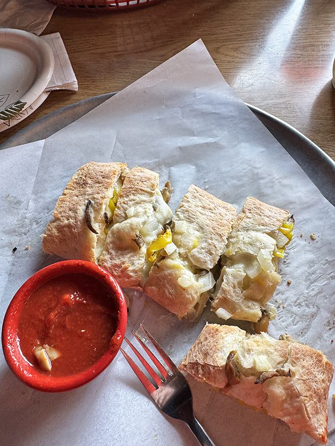 The Stromboli – pizza's sophisticated cousin who studied abroad. Crispy on the outside, molten goodness within, and that dipping sauce deserves a sonnet.
