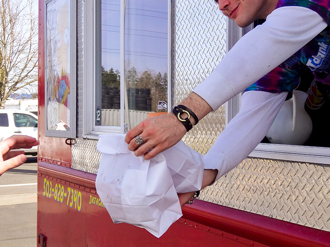 The sacred exchange – food lovingly prepared, carefully packaged, and handed to an eager customer. This moment of anticipation is almost as good as the first bite.