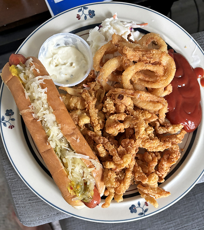 The "why choose?" platter – featuring a hot dog dressed for success, crispy clam strips, and enough condiments to satisfy any dipping enthusiast.