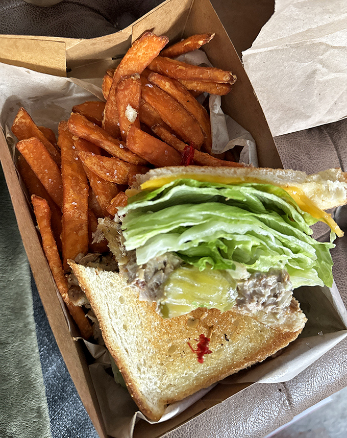 Sweet potato fries and a sandwich in perfect harmony—like a culinary duet that knows exactly when to let each flavor take the spotlight.