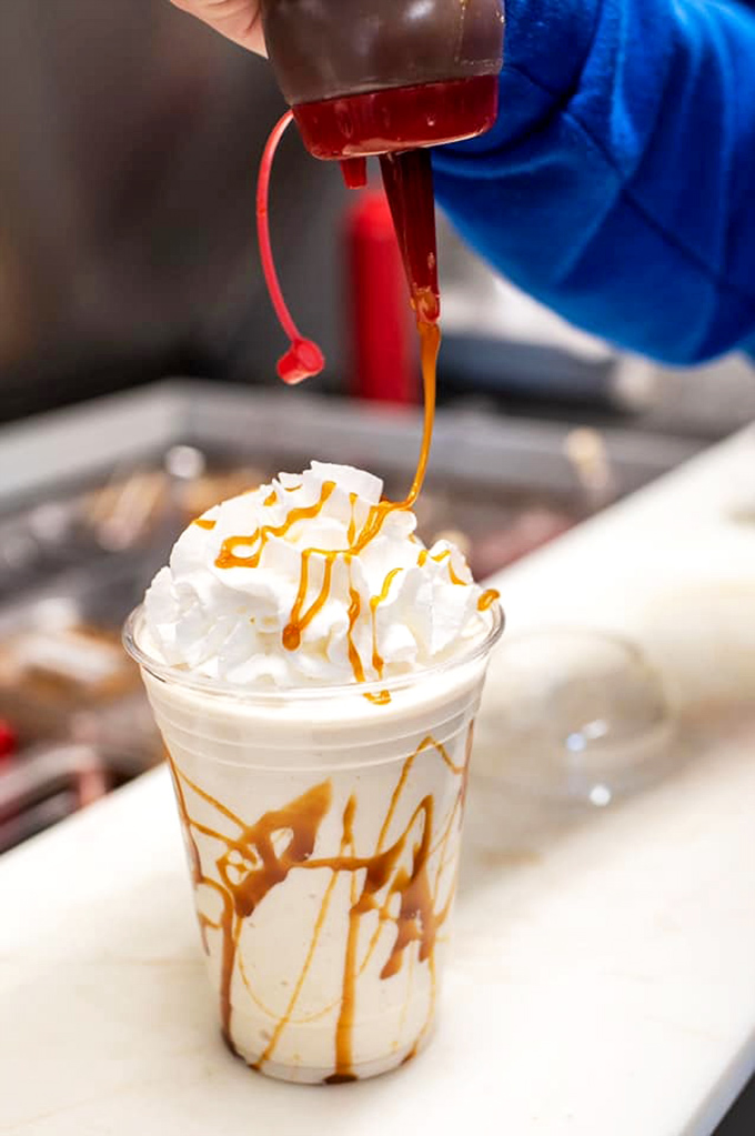 Watching caramel cascade down whipped cream mountains is the adult equivalent of seeing presents under the Christmas tree—pure, unadulterated joy.