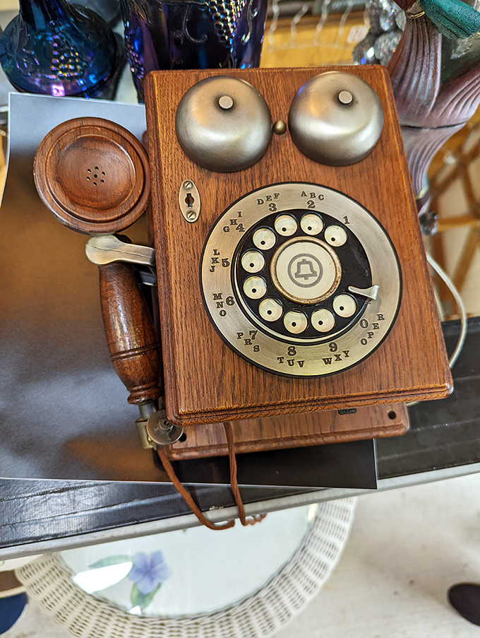 This vintage telephone doesn't just connect calls—it connects generations, standing as a wooden and brass monument to communication's simpler days.