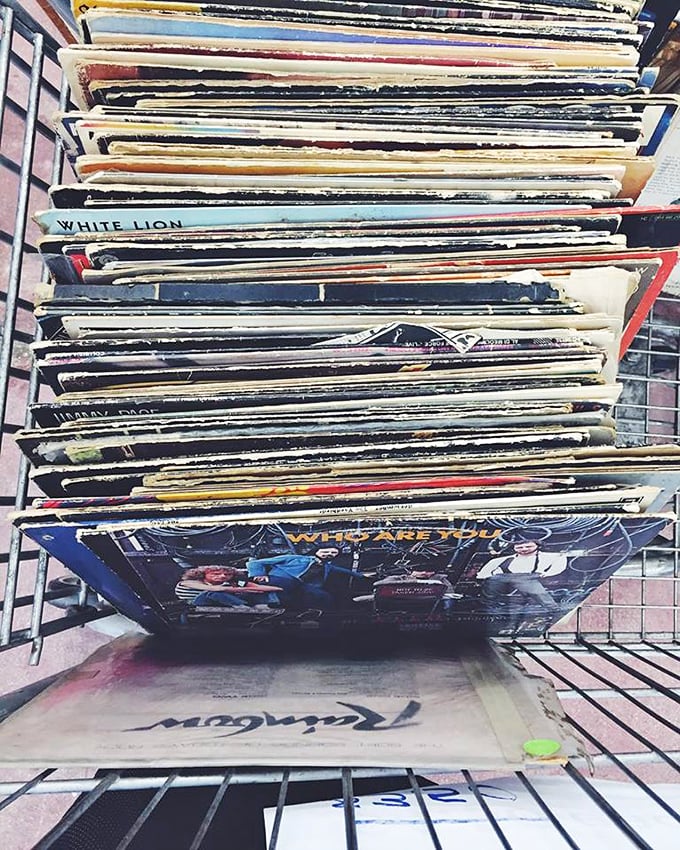 Vinyl records stacked like pancakes at a diner—each one a portal to another era's soundtrack, waiting for their next spin.