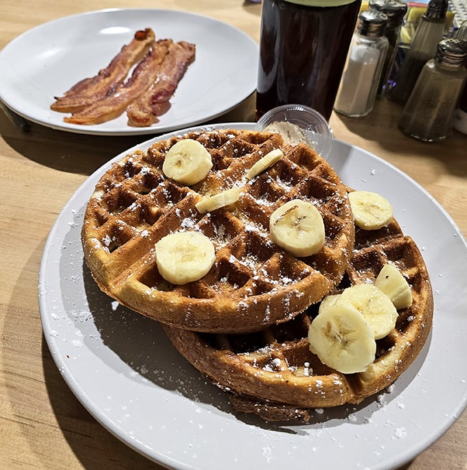 These waffles don't need a Belgian passport to prove their authenticity—just bananas, powdered sugar, and your immediate attention.