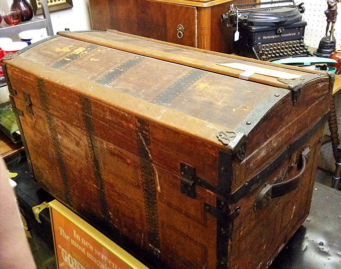 This weathered steamer trunk has likely crossed oceans and continents before landing here. If only it could talk—what adventures it would share!