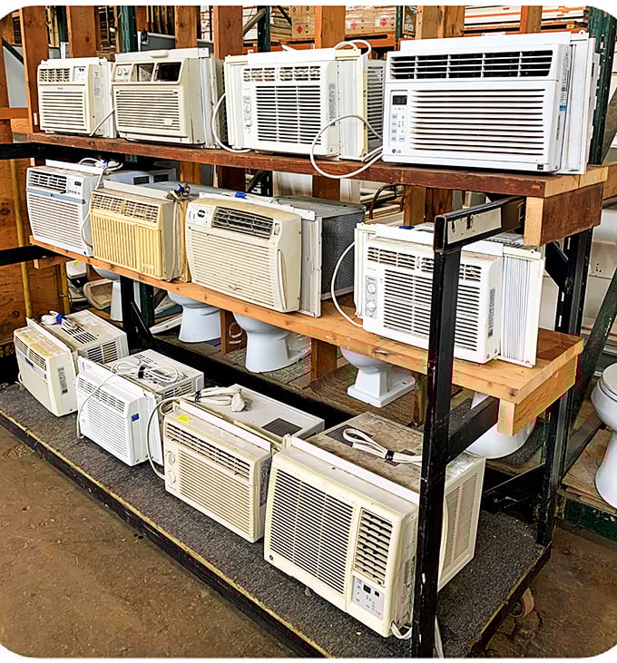 The air conditioner graveyard: where cooling units go for their second act, lined up like contestants in the world's most practical beauty pageant.