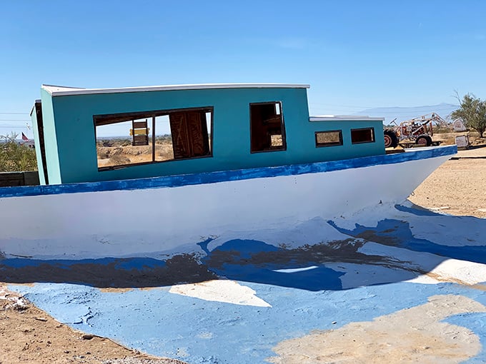 Even boats find new purpose here. This landlocked vessel sails on waves of paint rather than water—a desert mirage made permanent.