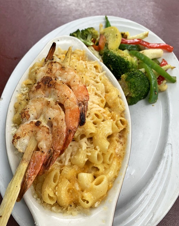 The shrimp perched atop this mac and cheese look like they've found the best seat in the house—and who could blame them?