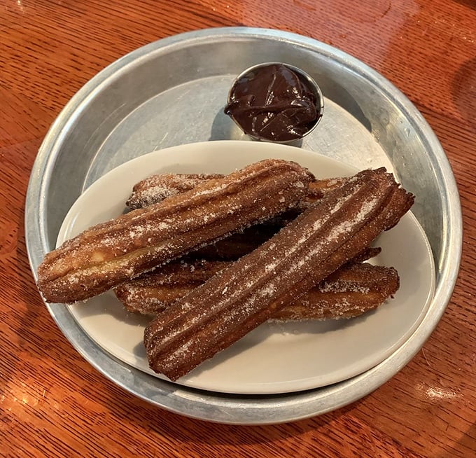 Churros that make you question your loyalty to chicken. Crispy, sugar-dusted dough sticks with chocolate dipping sauce—the dessert equivalent of a standing ovation.