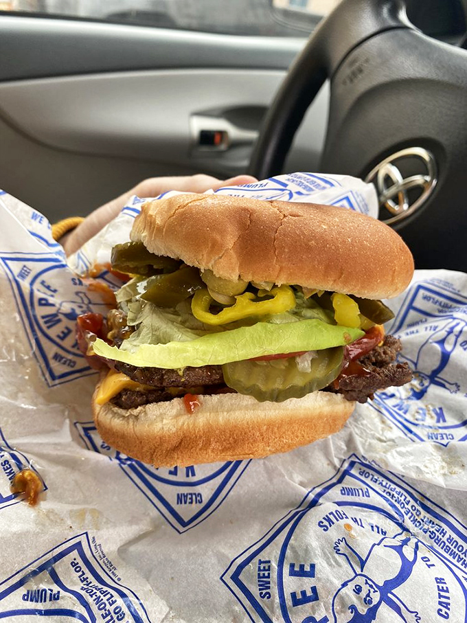 Car dining at its finest—this fully-loaded burger transforms your vehicle into the best restaurant in town, napkins absolutely required.
