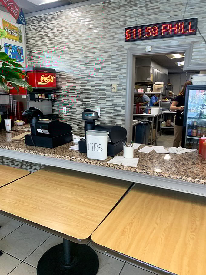 The counter where magic happens—complete with a tip jar that's earned every dollar through decades of keeping coffee cups filled.