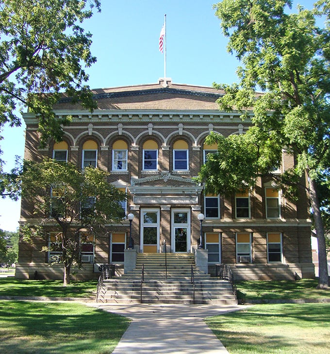 The courthouse commands respect with its brick solidity and architectural flourishes, democracy's outpost on the Nebraska prairie.