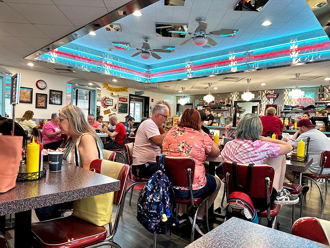 The bustling dining room proves the universal truth—good food brings people together, especially when surrounded by authentic 50s charm and neon lights.