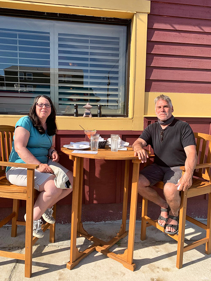 Outdoor dining with a view of Carolina Beach's charm—where conversations flow as easily as the cocktails.