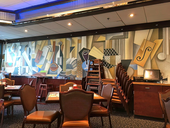 Art meets appetite with this striking mural adorning the dining area – proof that diner culture has always appreciated both form and function.