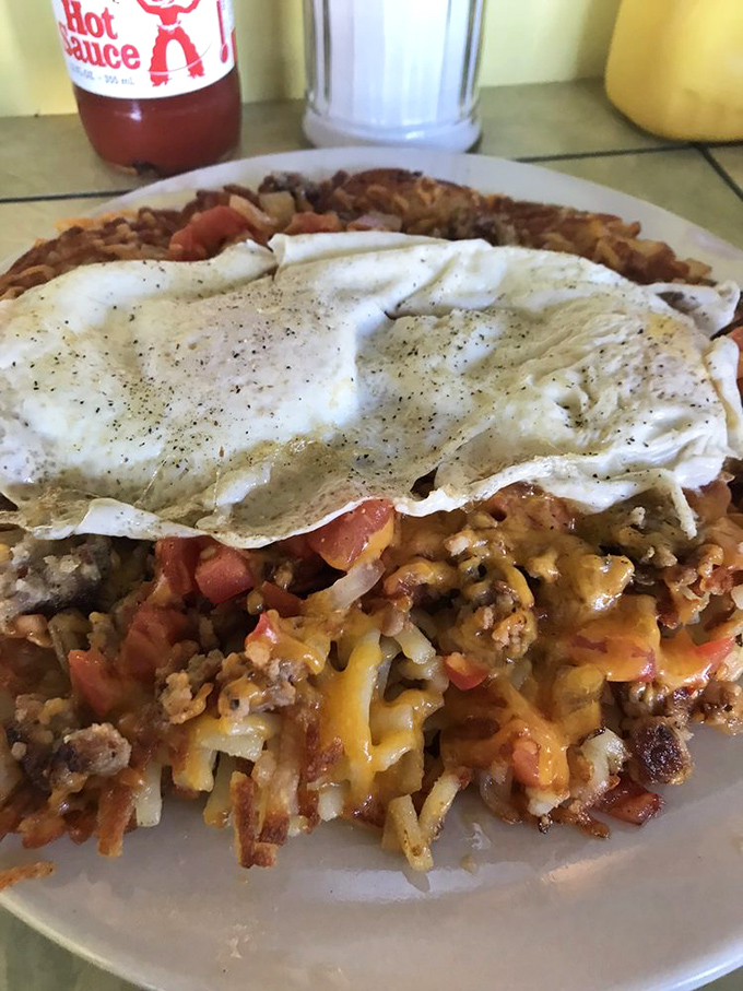 Behold: the breakfast equivalent of a magic trick. Perfectly cooked eggs crowning a mountain of hash browns and seasoned meat that would make any morning magnificent.