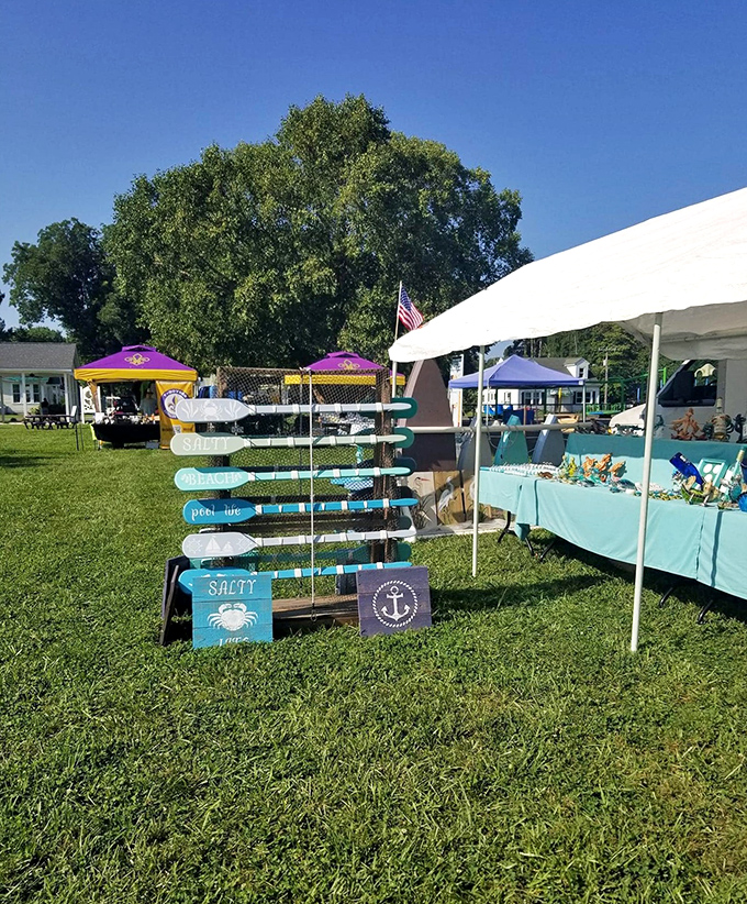 Coastal craftsmanship on display at the farmers market, where "SALTY" isn't just a sign – it's the perfect description of both the merchandise and the characters selling it.