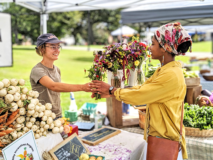 The farmers market showcases the human connection behind our food, where buying turnips becomes a conversation and flowers are exchanged with genuine smiles.