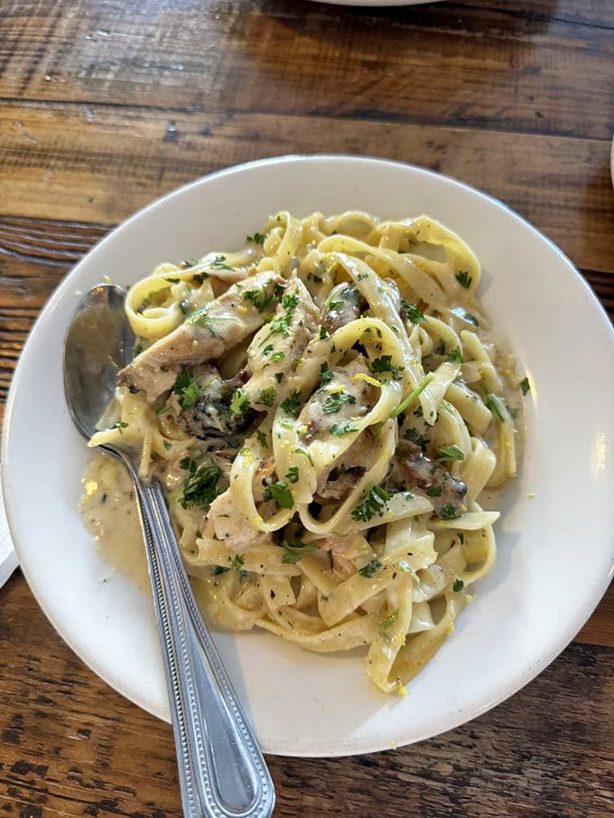 Fettuccine that doesn't just sit on the plate but performs—creamy, rich, and twirling around your fork like it's auditioning for a pasta commercial.