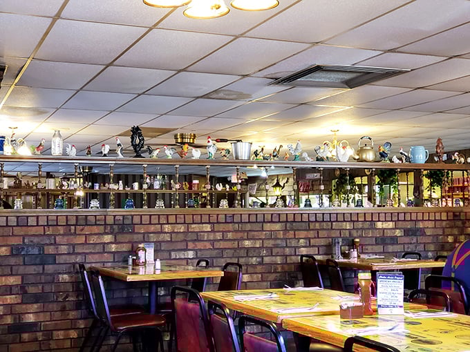 A collection of chicken figurines watches over diners like guardians of a sacred tradition – a quirky touch that adds to the charm.