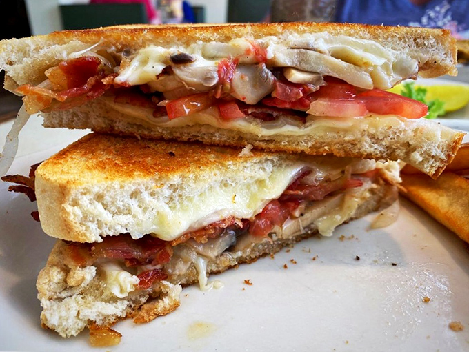 This isn't just a sandwich—it's a grilled cheese masterpiece with layers of melty goodness and fresh tomato that would make any childhood memory jealous.