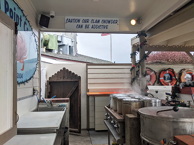 The kitchen where magic happens, complete with a warning sign that their clam chowder "can be addictive"—the most honest advertising ever.