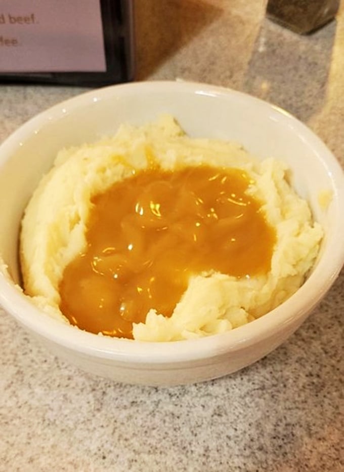 Mashed potatoes with a golden pool of gravy—the kind that makes you want to call your mother and apologize for ever saying anyone's were better.