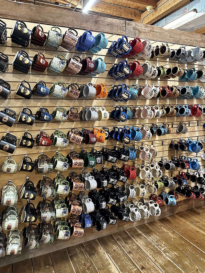 A wall of mugs that tells stories of travelers past. Pick your personality—are you a black bear, mountain scene, or quirky quote person?